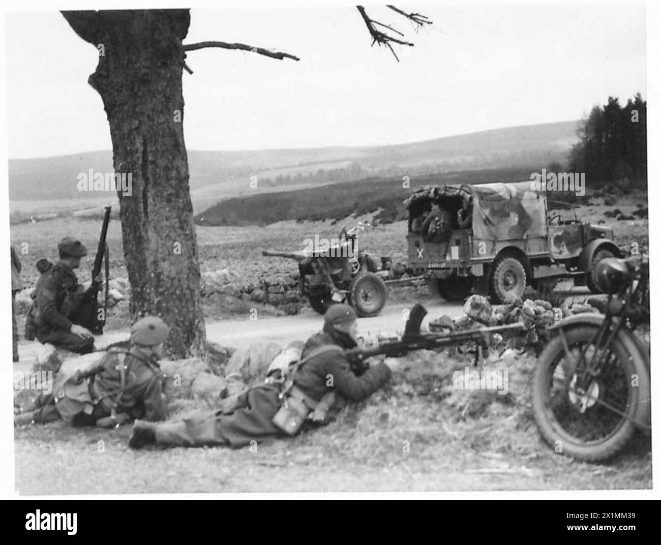 IN BONNIE SCOTLAND - An anti-tank rifleman covering an anti-tank gun on ...