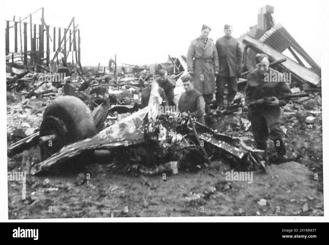 Anti-aircraft gunners examine the wreckage of a German raider destroyed ...