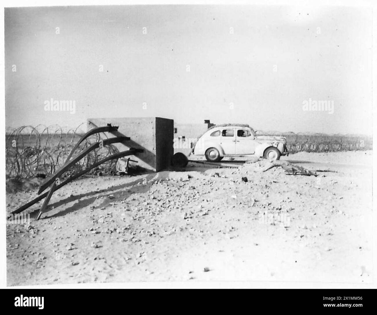An Australian staff car passes the Bardia defences, featuring concrete ...