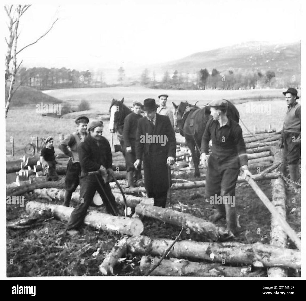 MR. PENSON VISITS SCOTTISH LUMBER CAMPS - Mr. Penson watching the ...