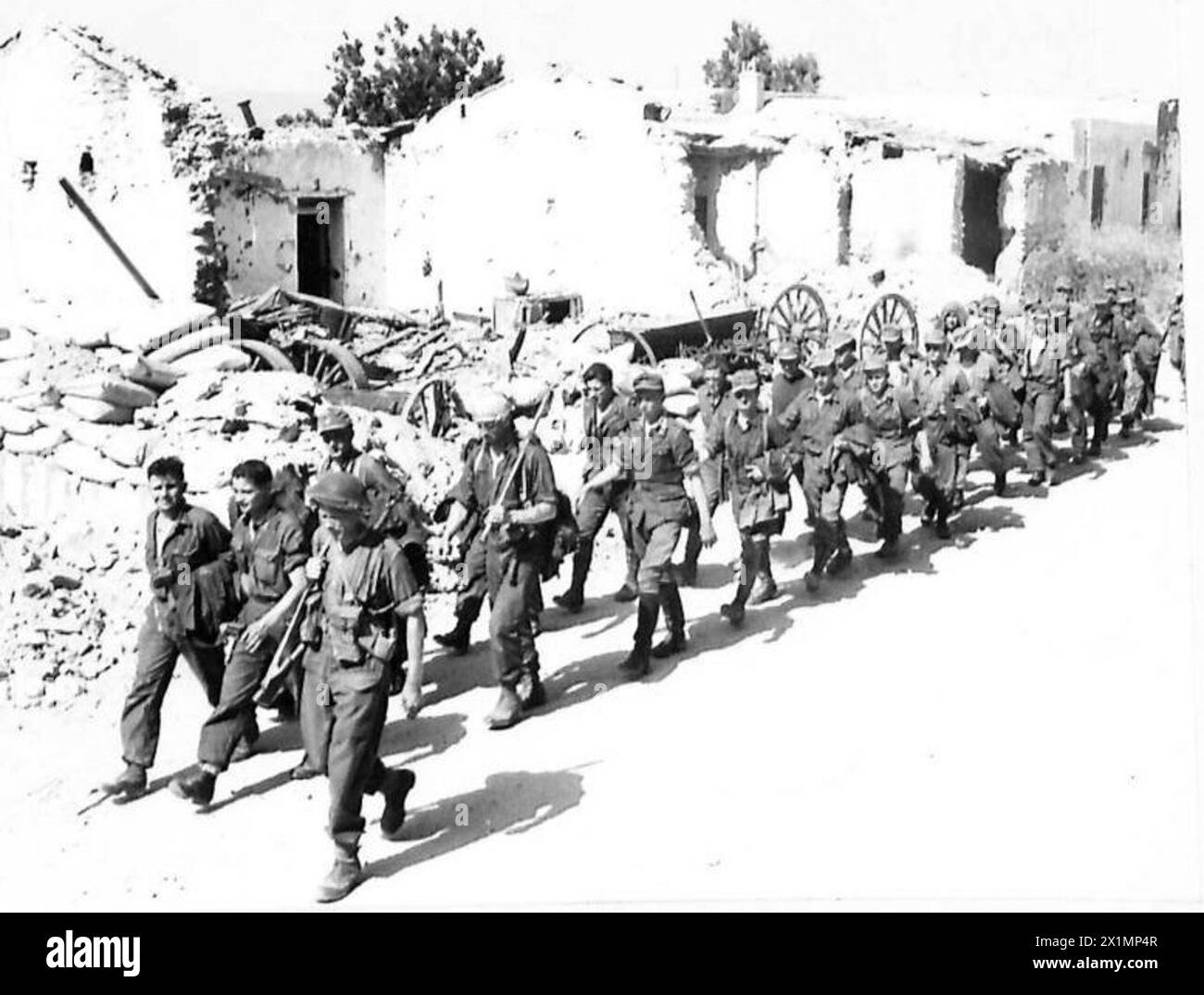WITH THE FIRST ARMY (VARIOUS) - A column of prisoners trudge wearily ...