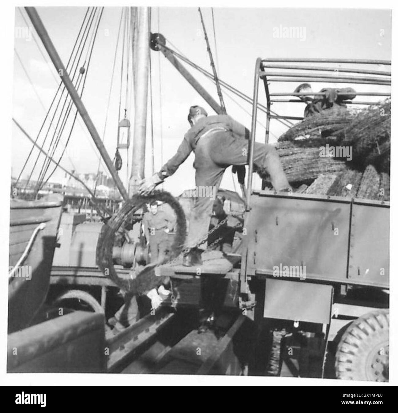 THE ARMY'S FLEET - Loading barbed wire into one of the craft , British ...