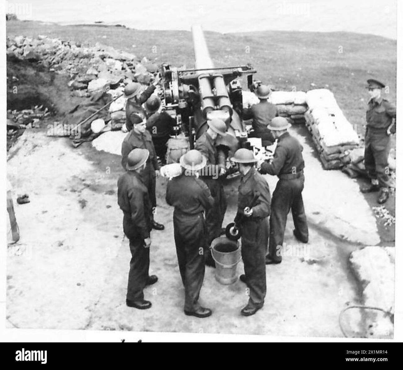 R.A. COASTAL DEFENCE BATTERY - Gun drill in progress, showing the shell ...