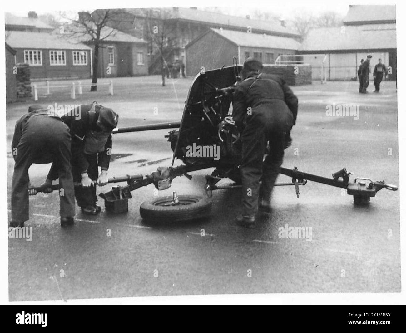 ANTI-TANK GUNNERS IN TRAINING - Mounting the anti-tank gun for action ...