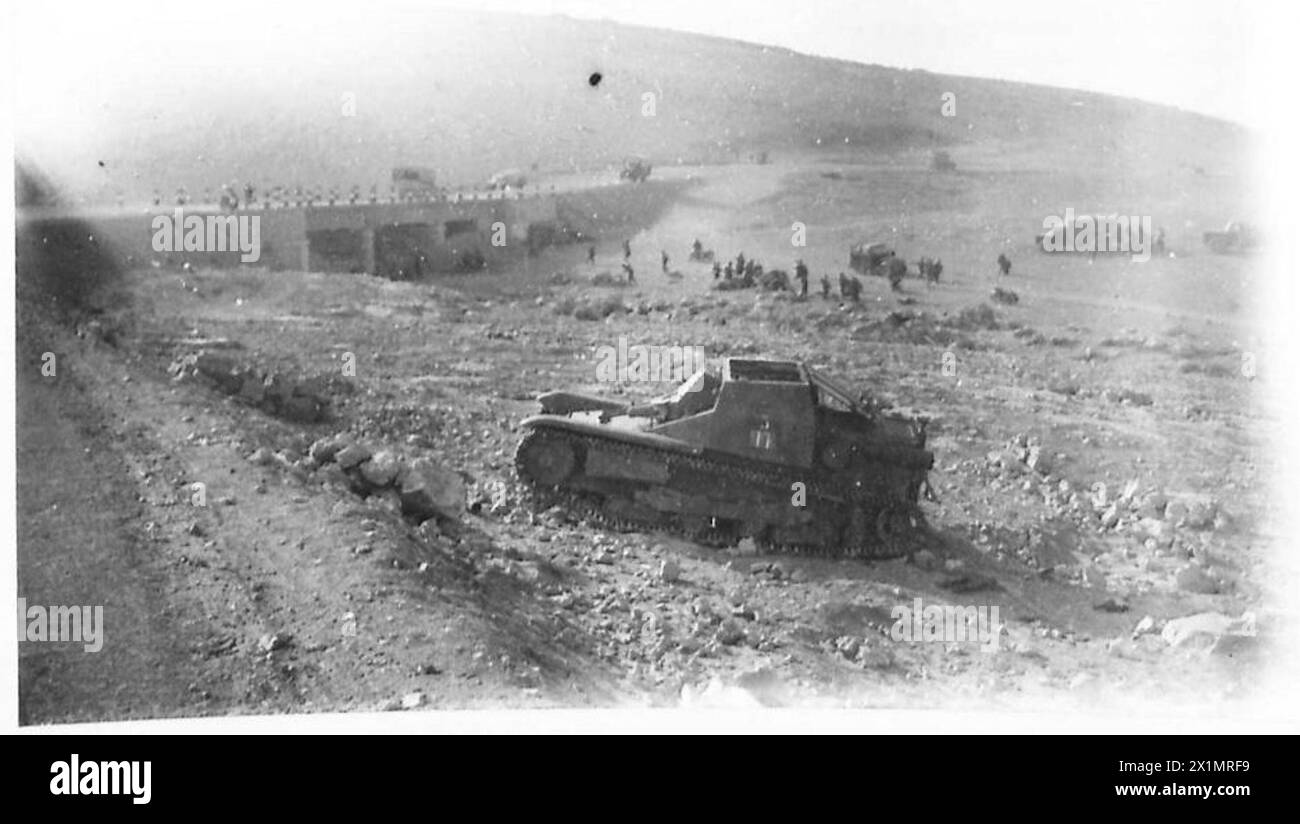 Deserted Italian defences and equipment are shown outside Bardia ...
