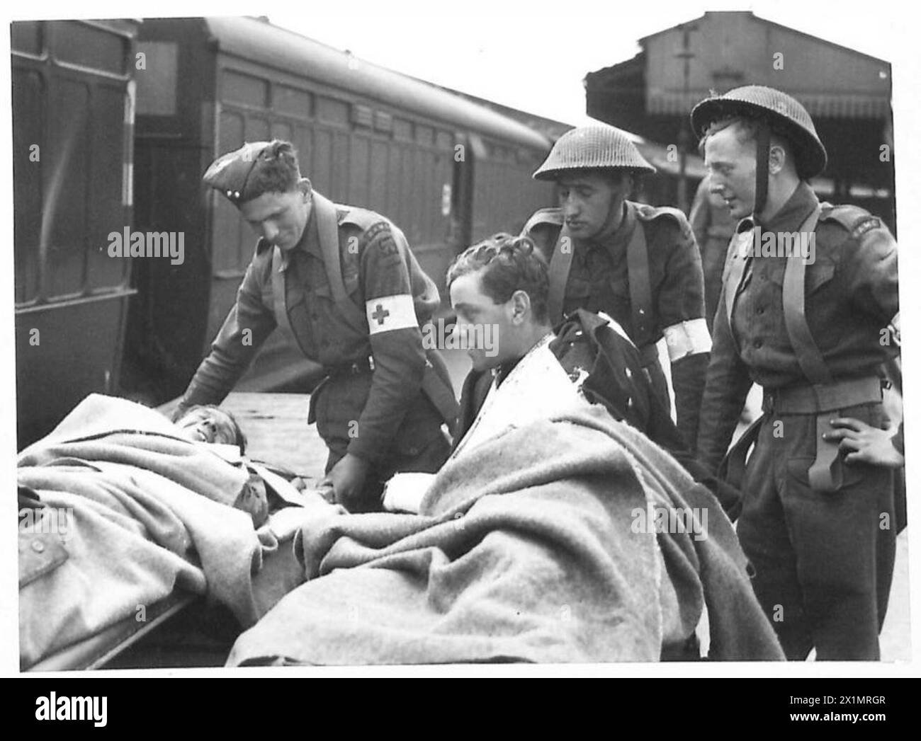 WOUNDED ARRIVE BACK FROM NORMANDY - Stretcher cases waiting to be put ...
