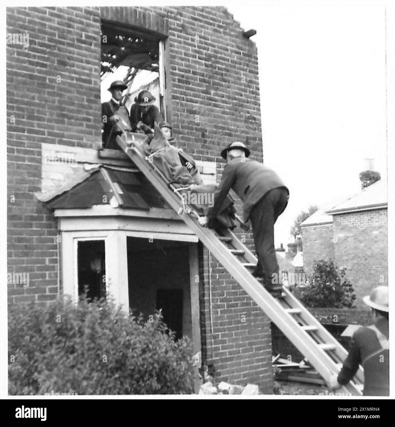 Civil defence units practice casualty evacuation from a demolished ...