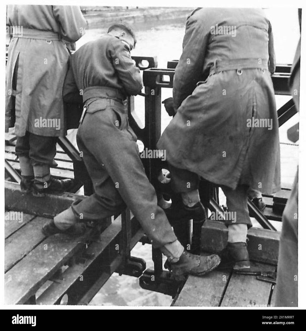 The Bailey Bridge is shown under construction by Royal Engineers ...
