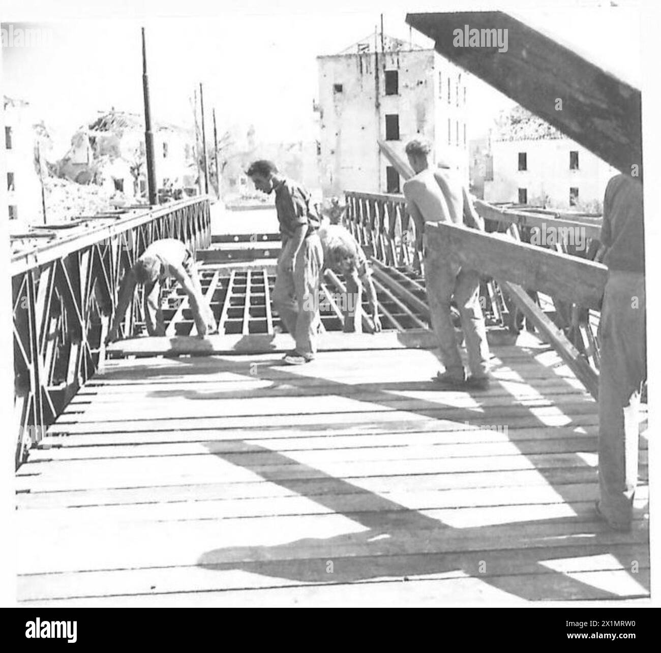 British Fifth Army sappers constructing a plank roadway across a bridge ...