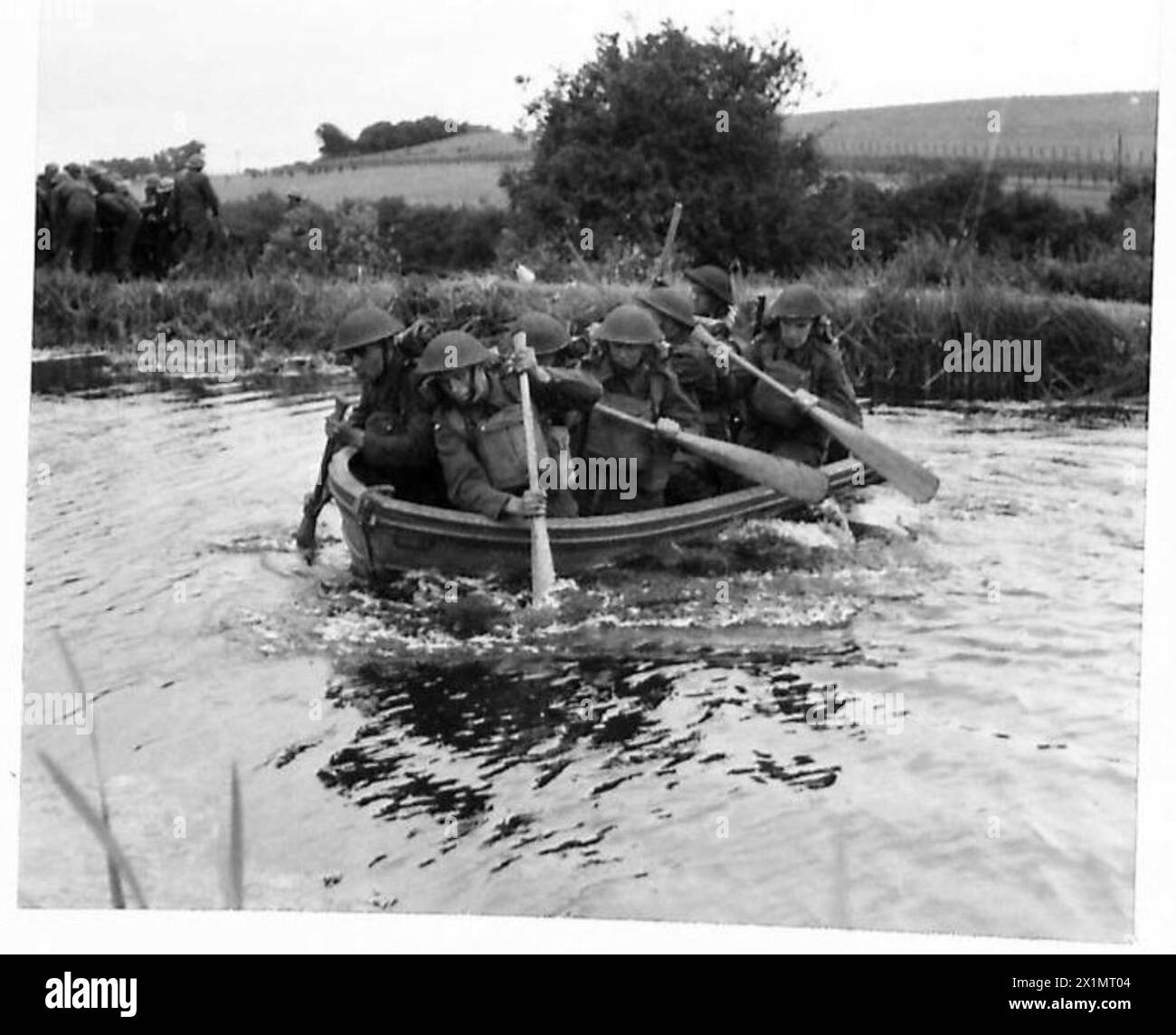 British Army troops cross a river in an assault boat during a bridging ...