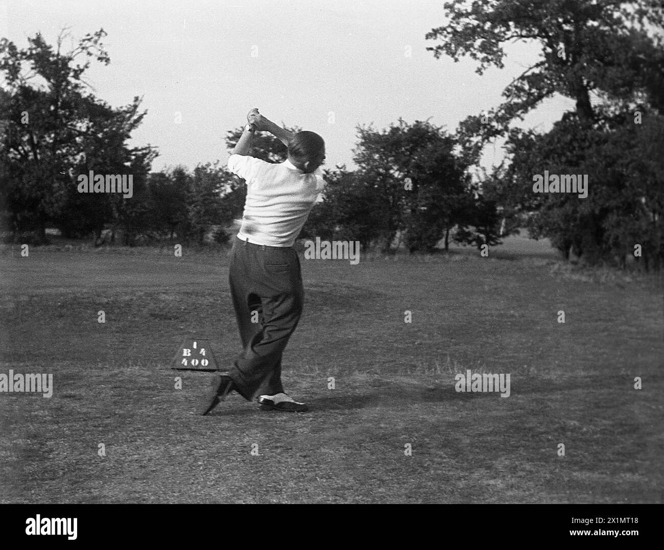 1950s, historical, a male golfer striking a ball off the tee on an ...