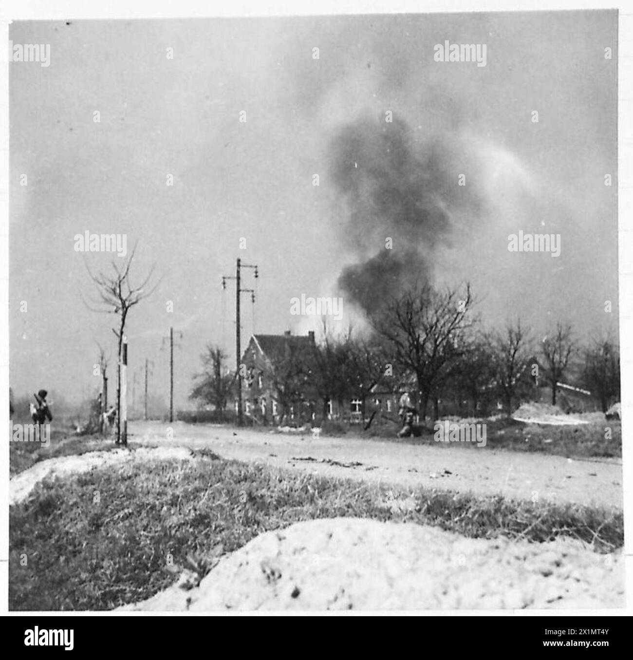 AIRBORNE TROOPS LAND EAST OF THE RHINE - A scene outside buring ...
