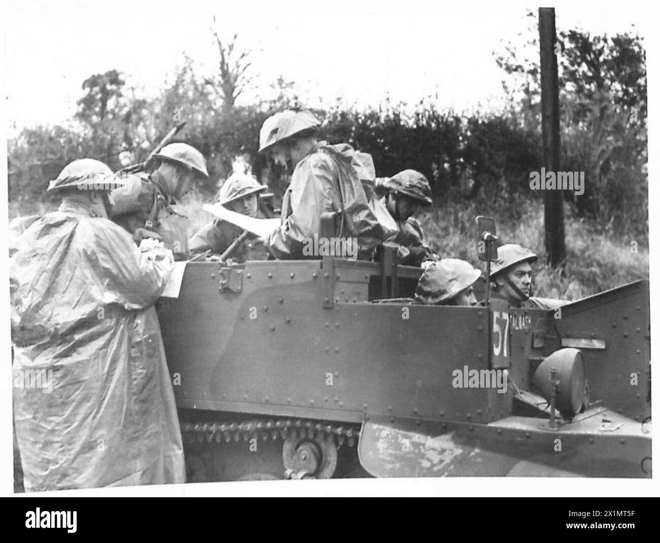 A Bren gun carrier crew receives instructions while the Guards are on ...