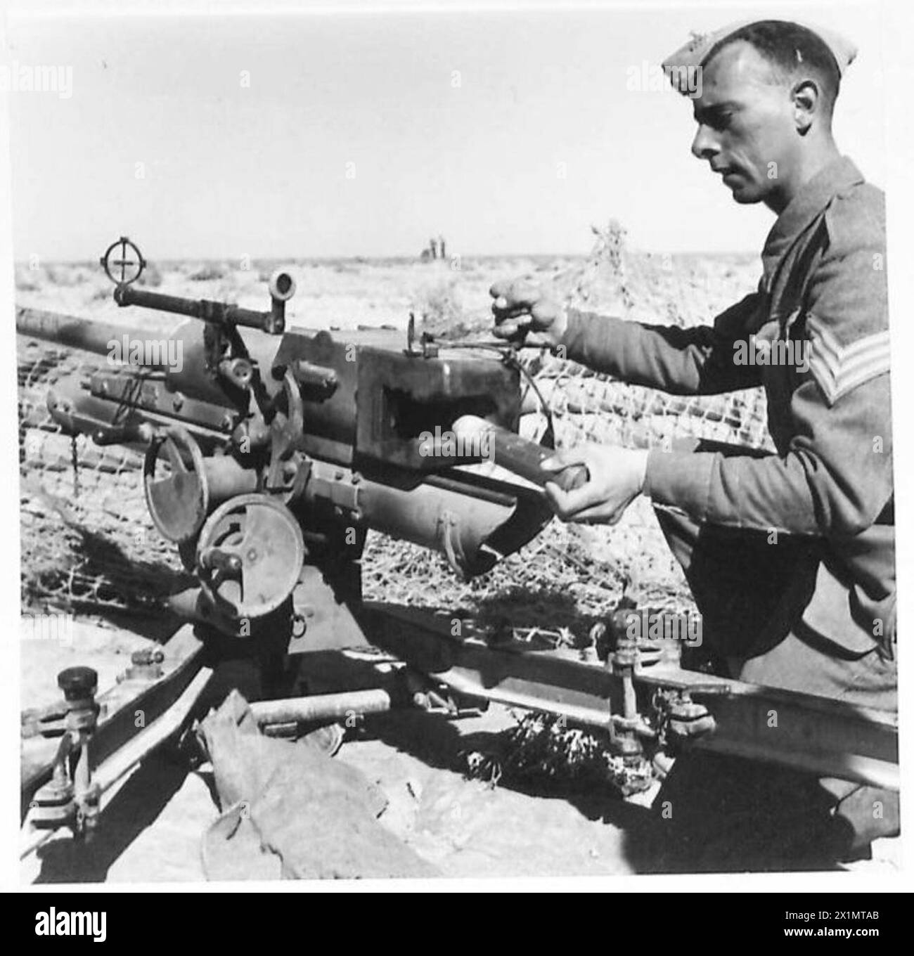 A captured Italian Breda anti-tank gun, modified with a sight, fires ...