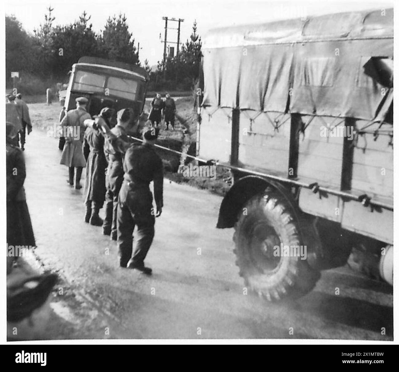 TWO DIVISIONS IN A MOCK BATTLE - Hauling out a ditched lorry. It was ...