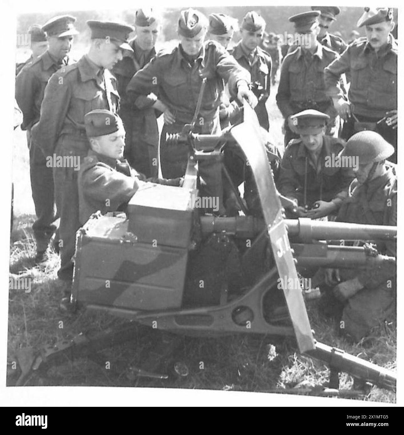Junior Army officers gather around a 2-pounder anti-tank gun for ...