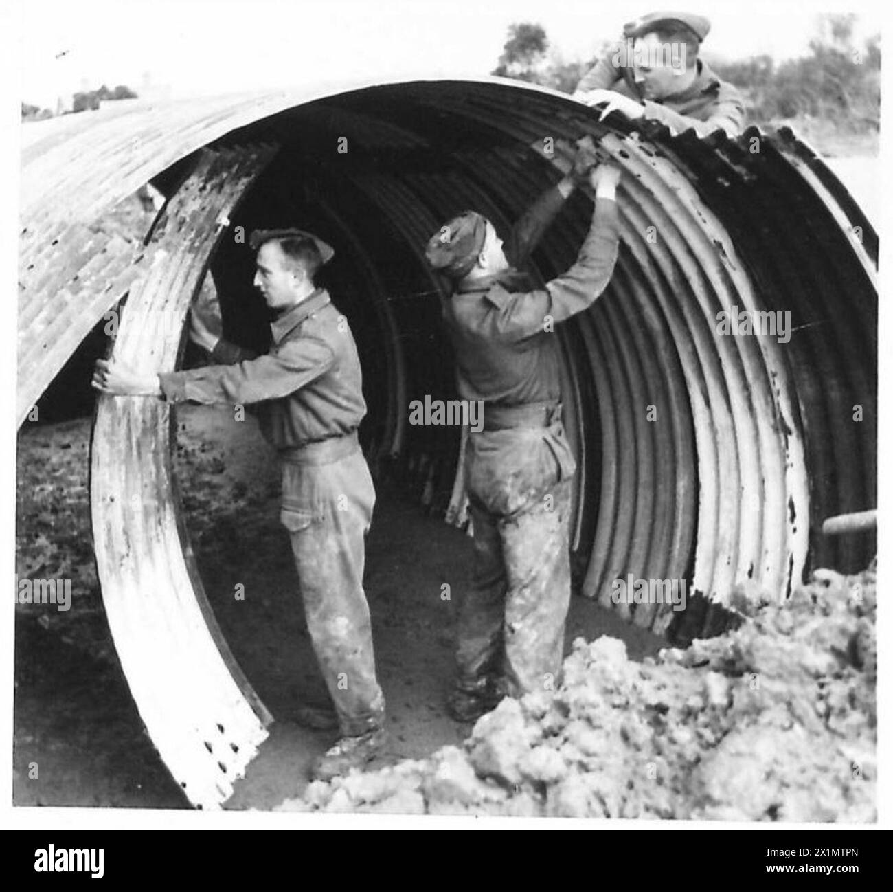 THE PIONEER CORPS - Men of the Pioneer Corps erect Nissen huts on an ...