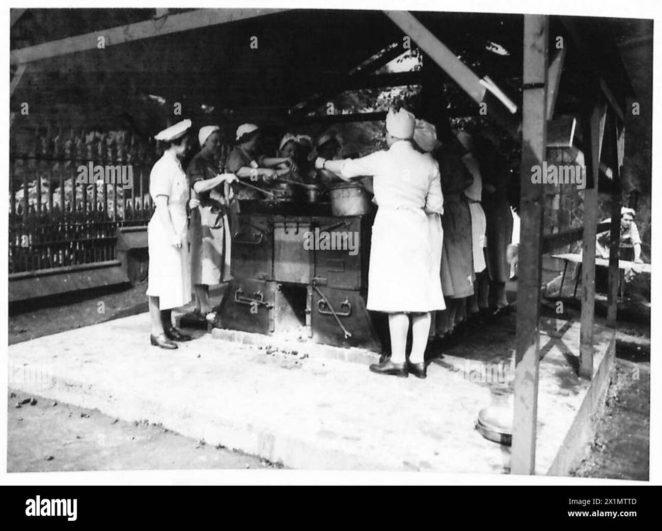 A.T.S. squad cooking using a 'Bluff' range during training exercises ...