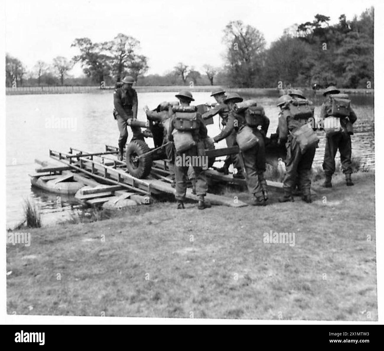 British Army soldiers transport a 6-pounder anti-tank gun and trucks ...