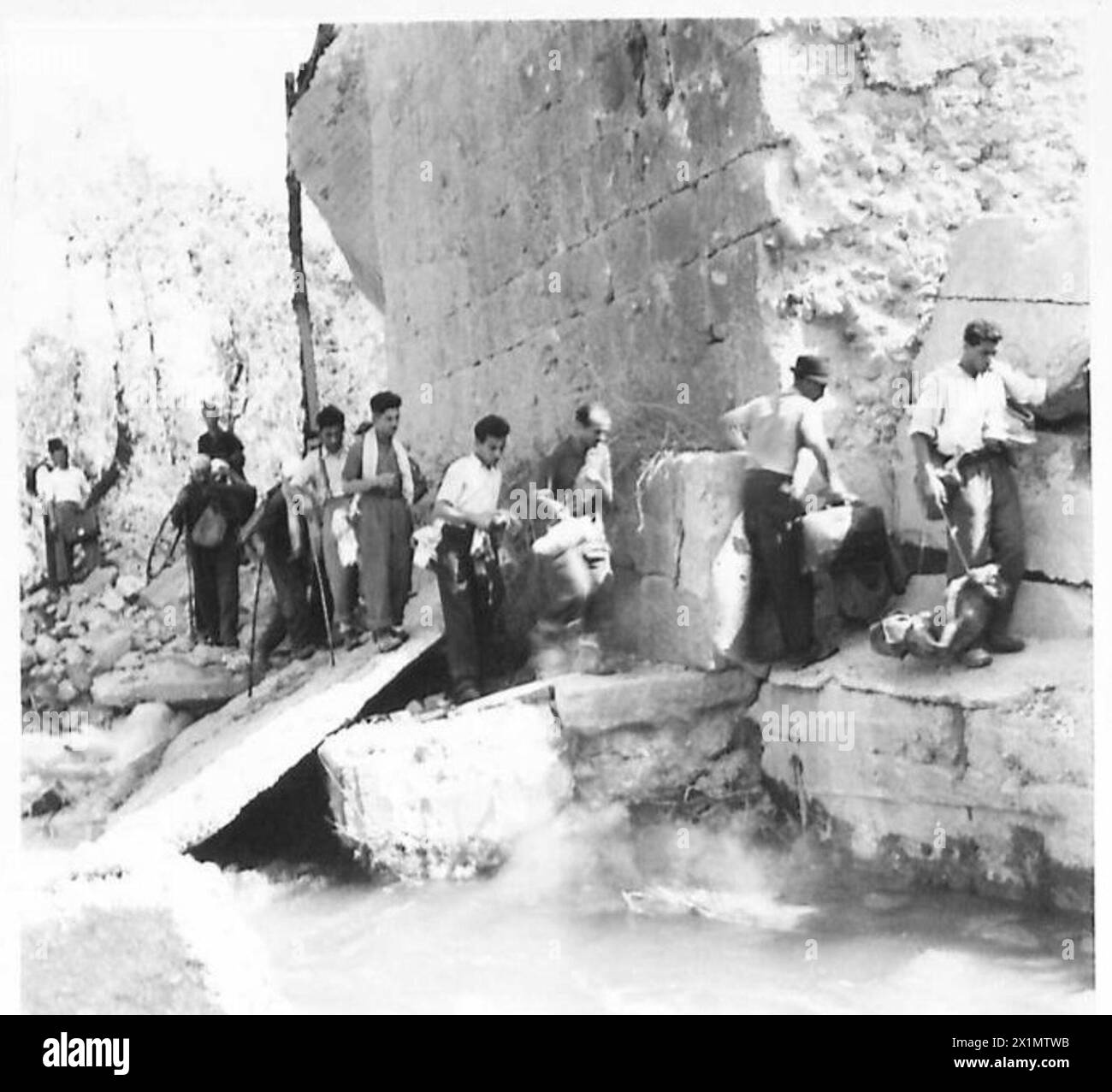 Civilians cross debris destroyed hi-res stock photography and images ...