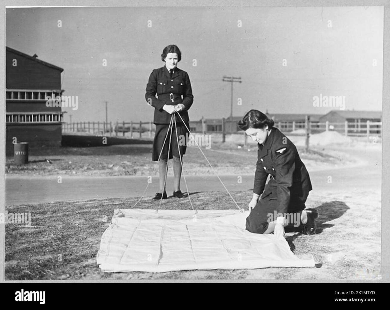R.A.F. SCHOOL FOR AIR GUNNERS : TRAINING SCENES - WAAF personnel carry ...