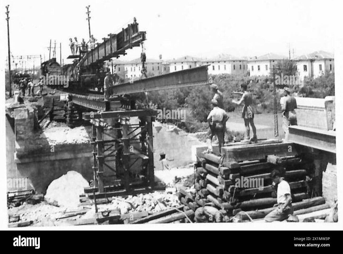 REBUILDING RAILWAY BRIDGES - The huge crane, pushed by a railway engine ...