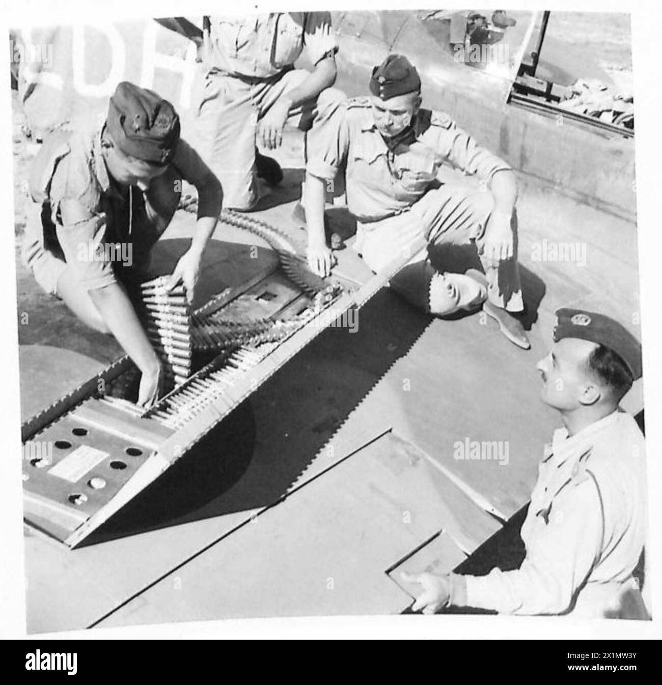 Infantry officers observe fighter-bombers armed with six Browning .5 ...