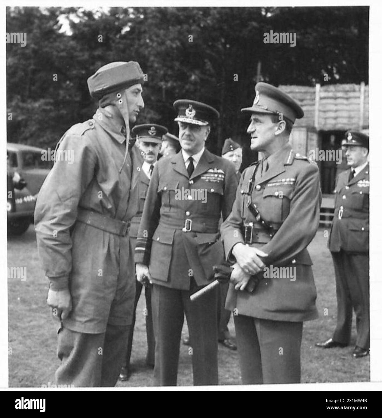 Army and Air Force commanders observe a young paratroop soldier after ...