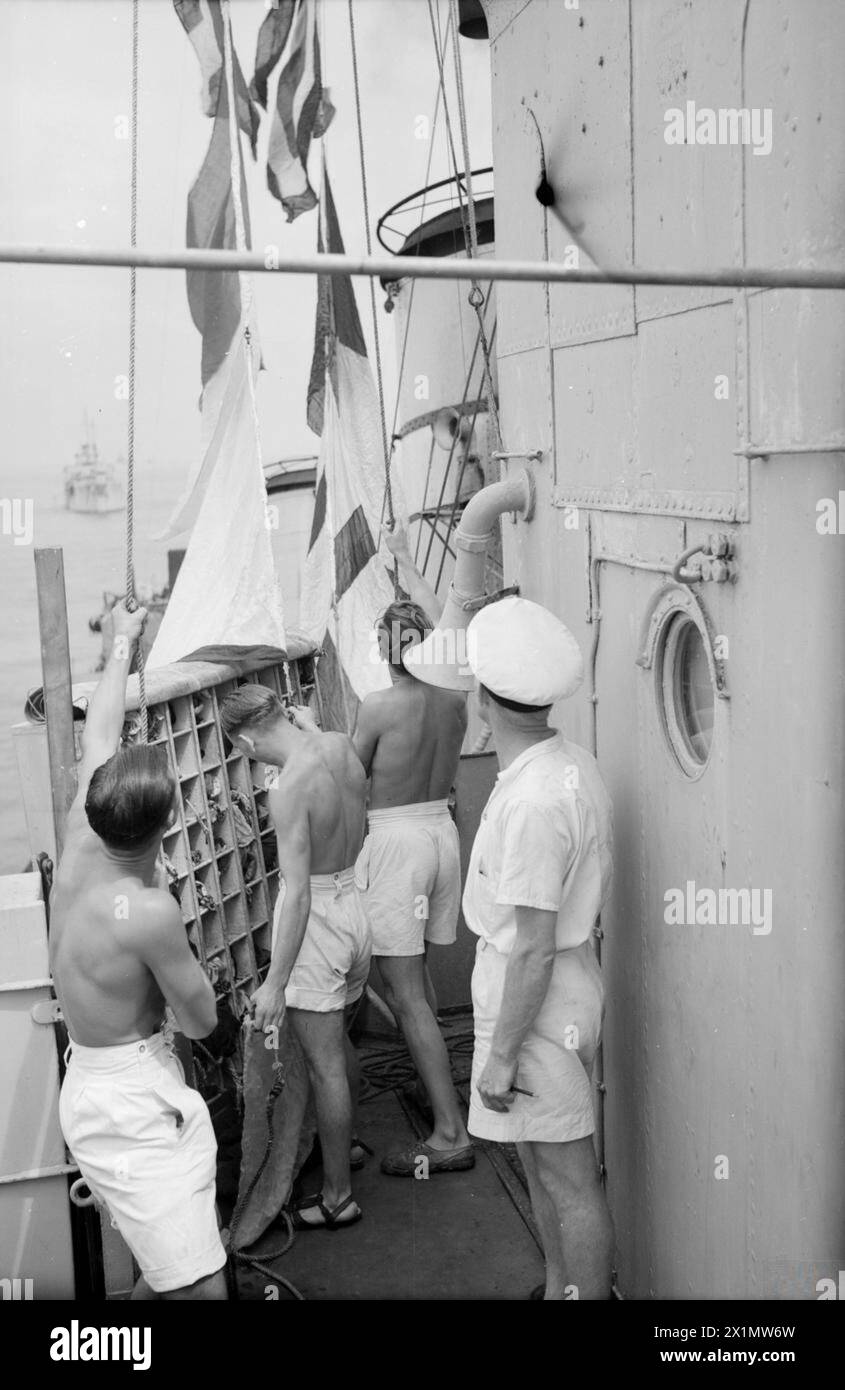 The Yeoman of Signals aboard HMS Foxhound supervises the hoisting of ...
