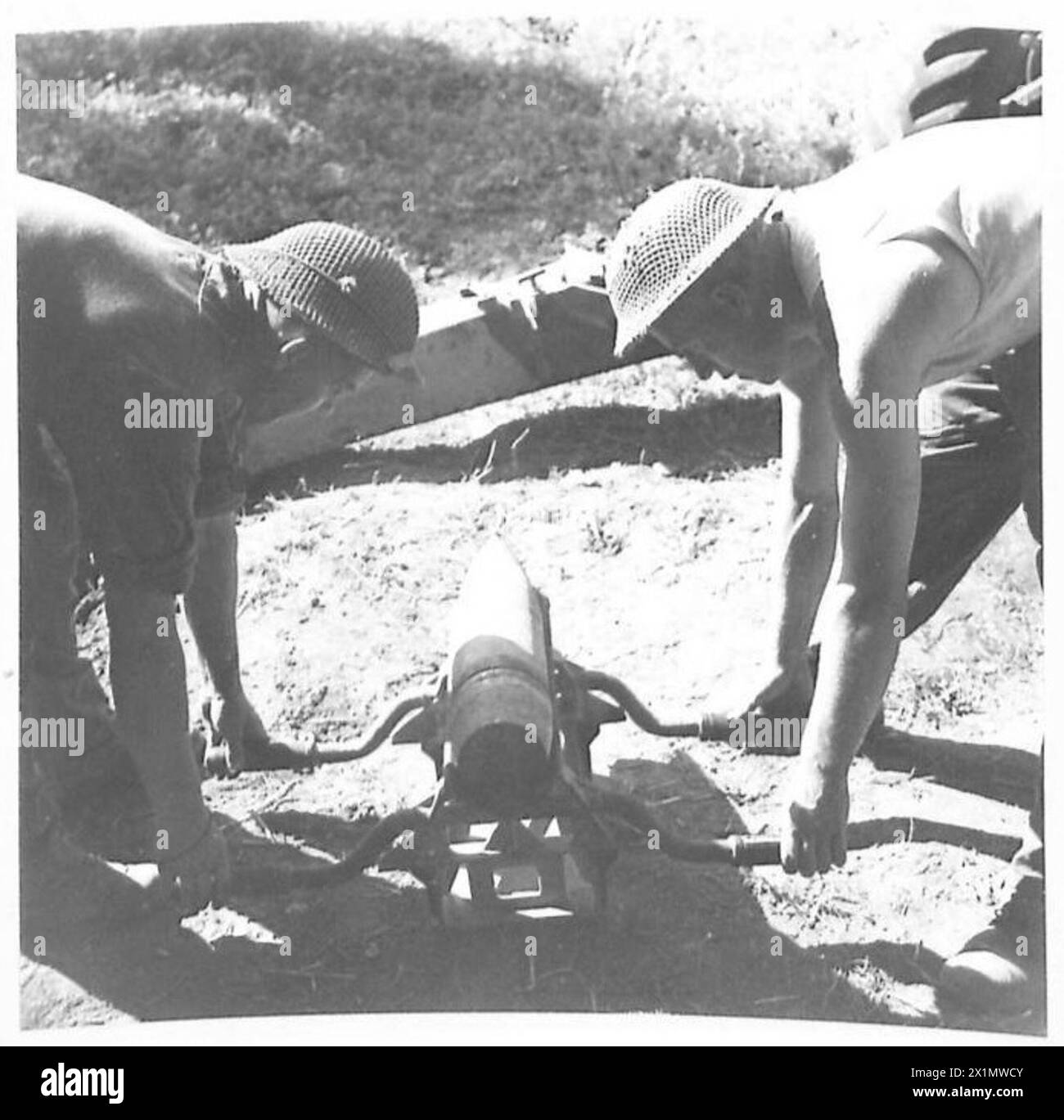 Loaders prepare to place a round onto the cradle of a 5.5-inch gun ...