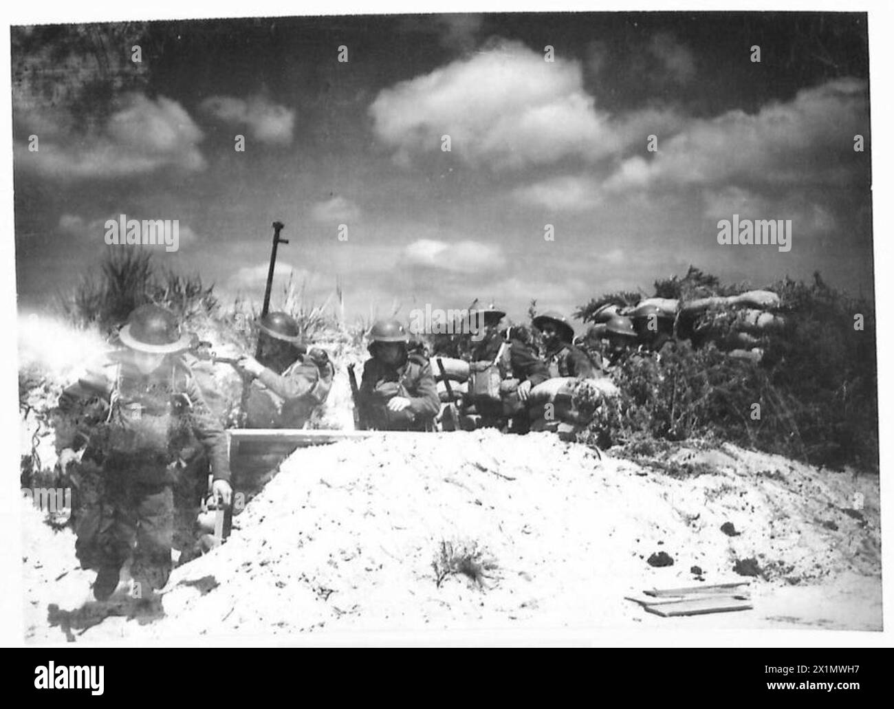 GREEN HOWARDS ON GUARD! - Troops moving along a seaside trench, one ...