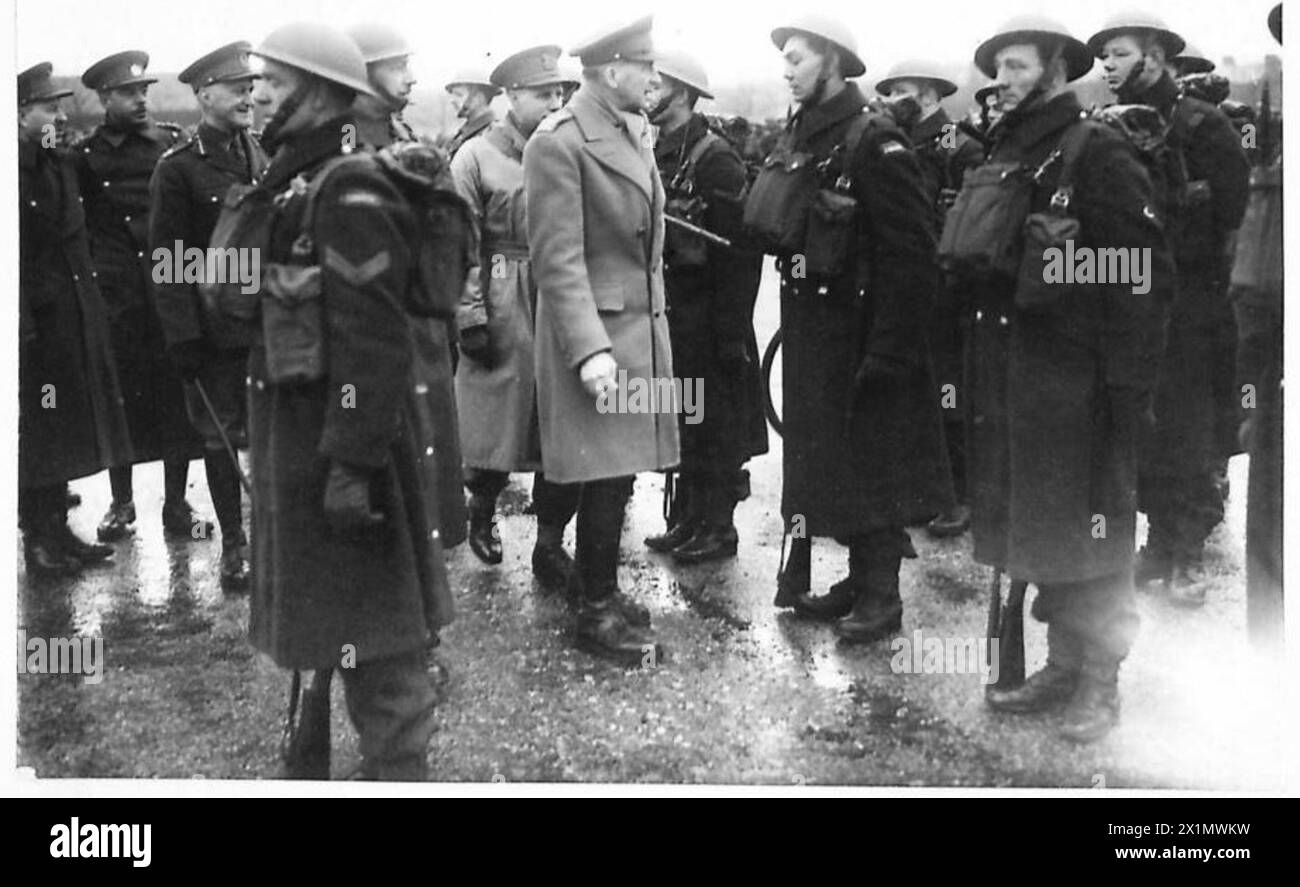 General Sir John Dill inspects Canadian forces, speaking with a soldier ...