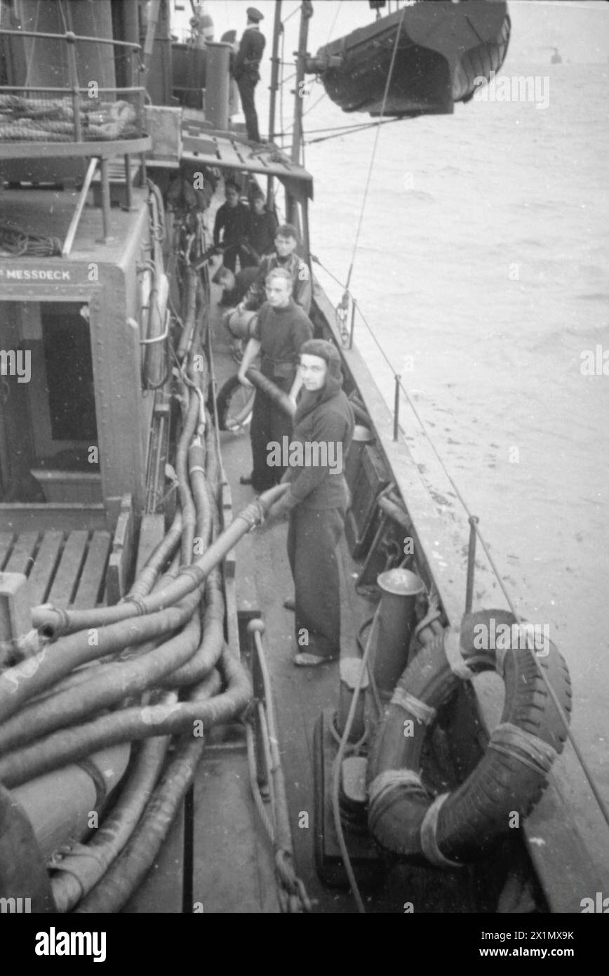 On board the minesweeper HMT Cayrian in 1940, crew members conduct ...