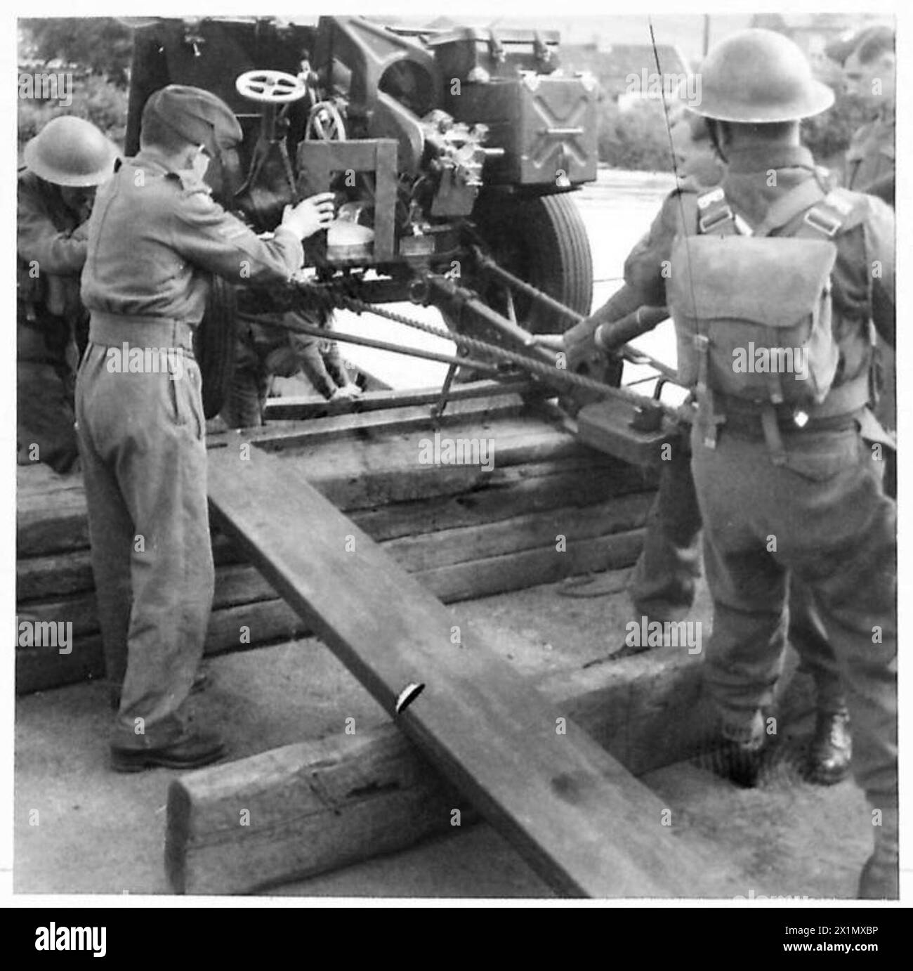 IMPROVISED RAFTS FOR GUNS - Unloading two pounder anti-tank guns from a ...
