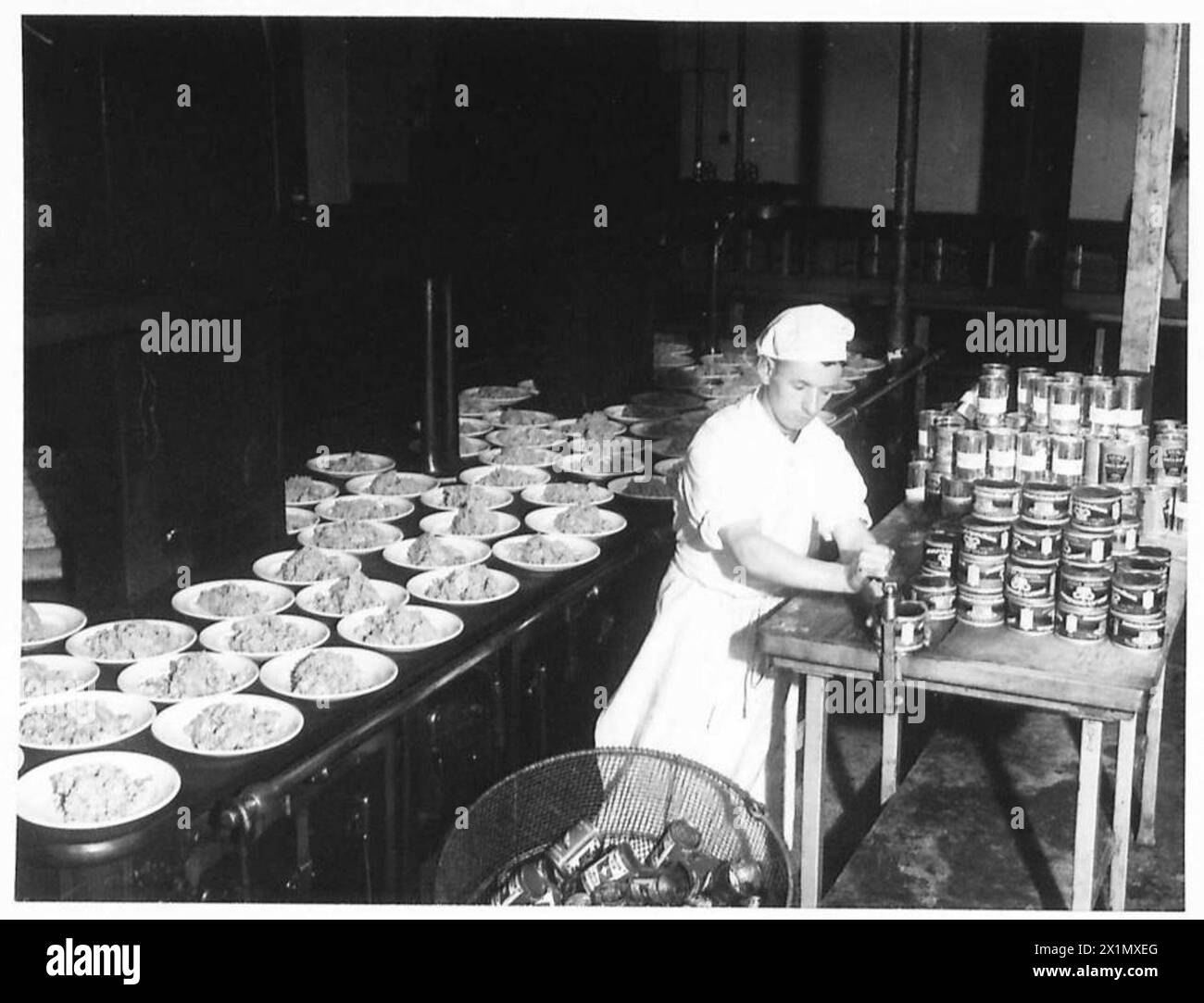Army cook opening sardine tins to prepare a team meal for soldiers ...