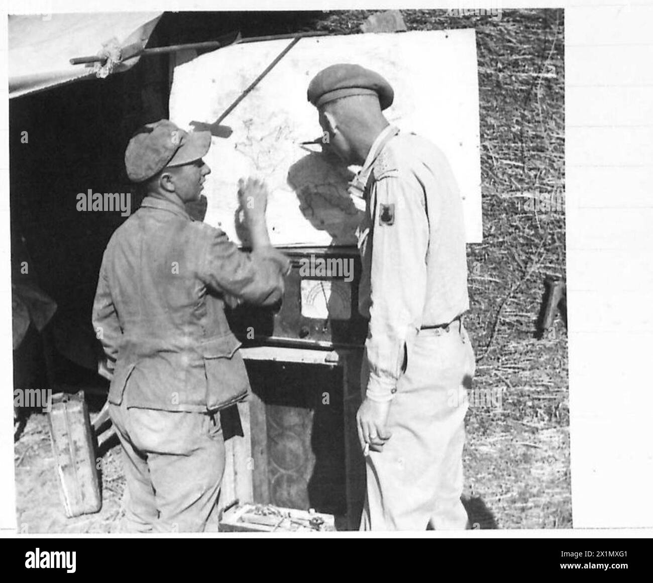 Captain C. Bennett of the Military Police explains the situation to a ...