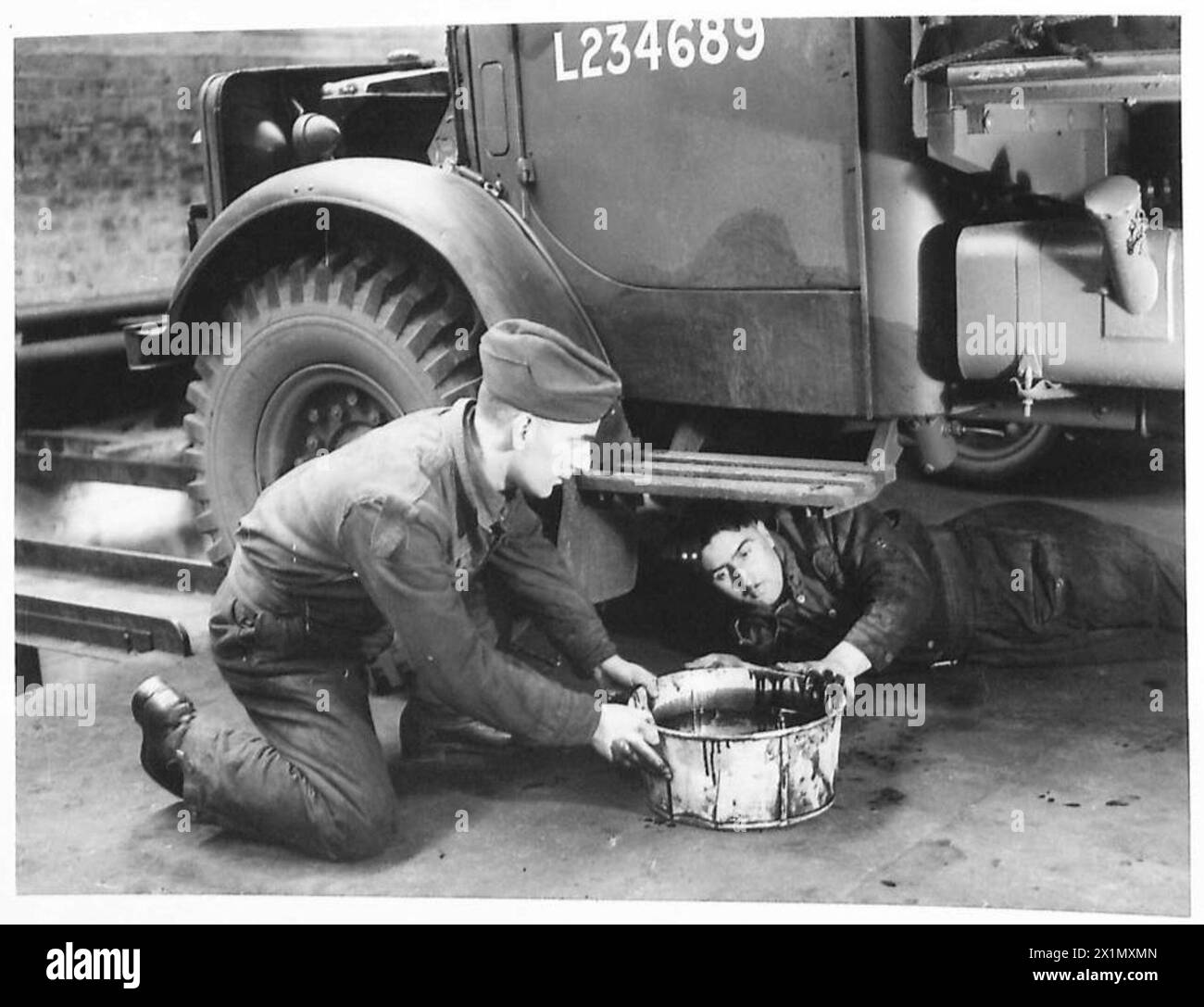 ARMY OIL SALVAGE - Passing used oil from underneath vehicle after ...