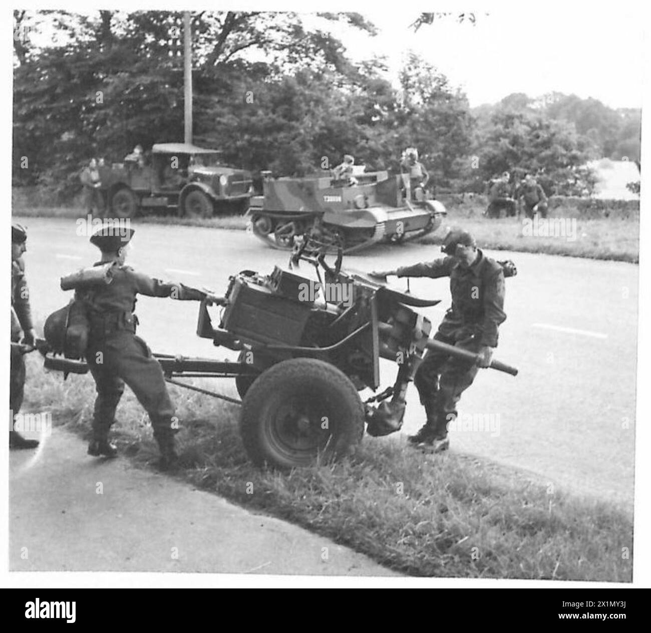 A BORDER EXERCISE - Troops manhandle an anti-tank gun into position ...
