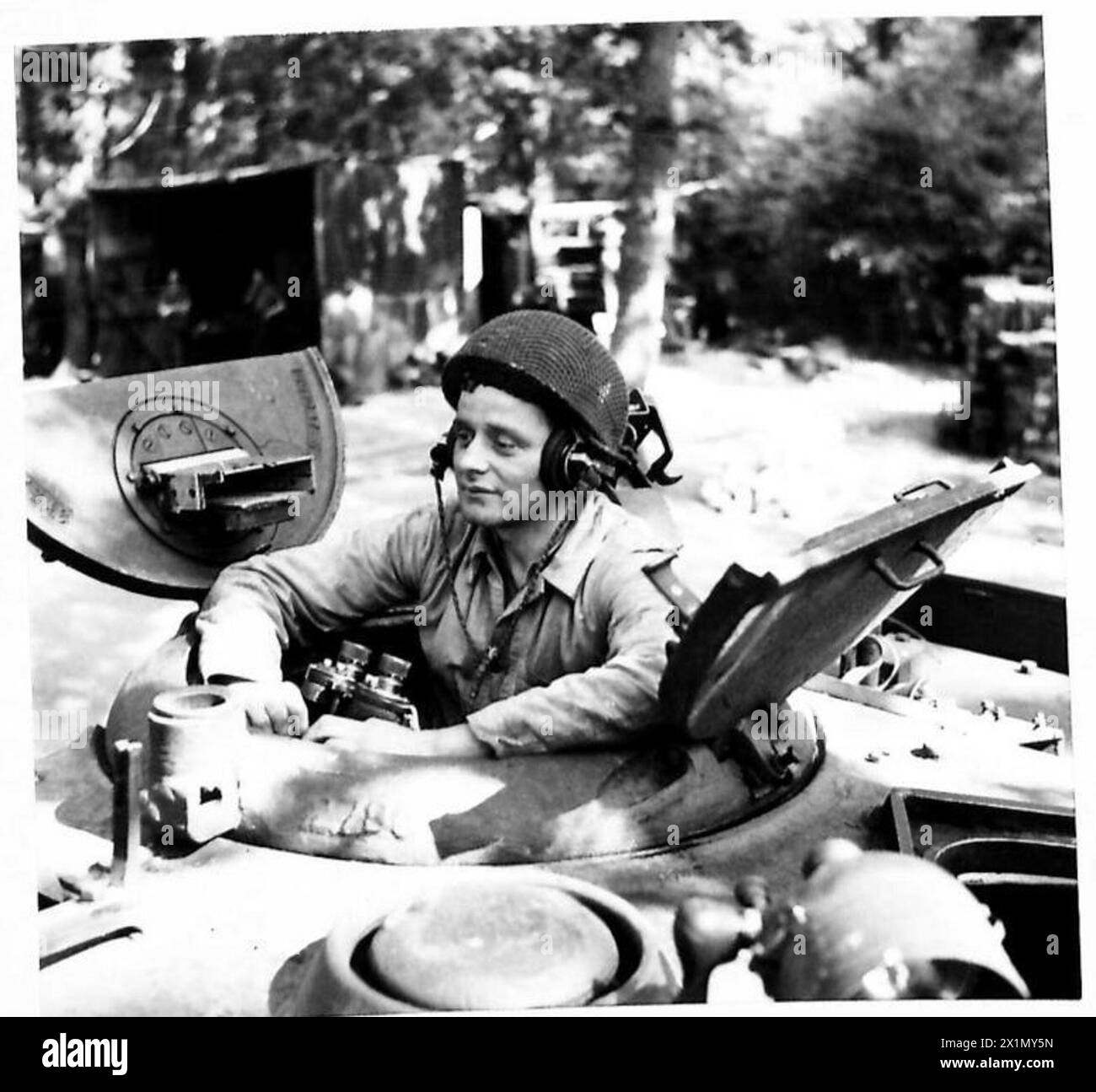 Sergeant S. Diver, MM, serves in the turret of a Sherman tank with the ...