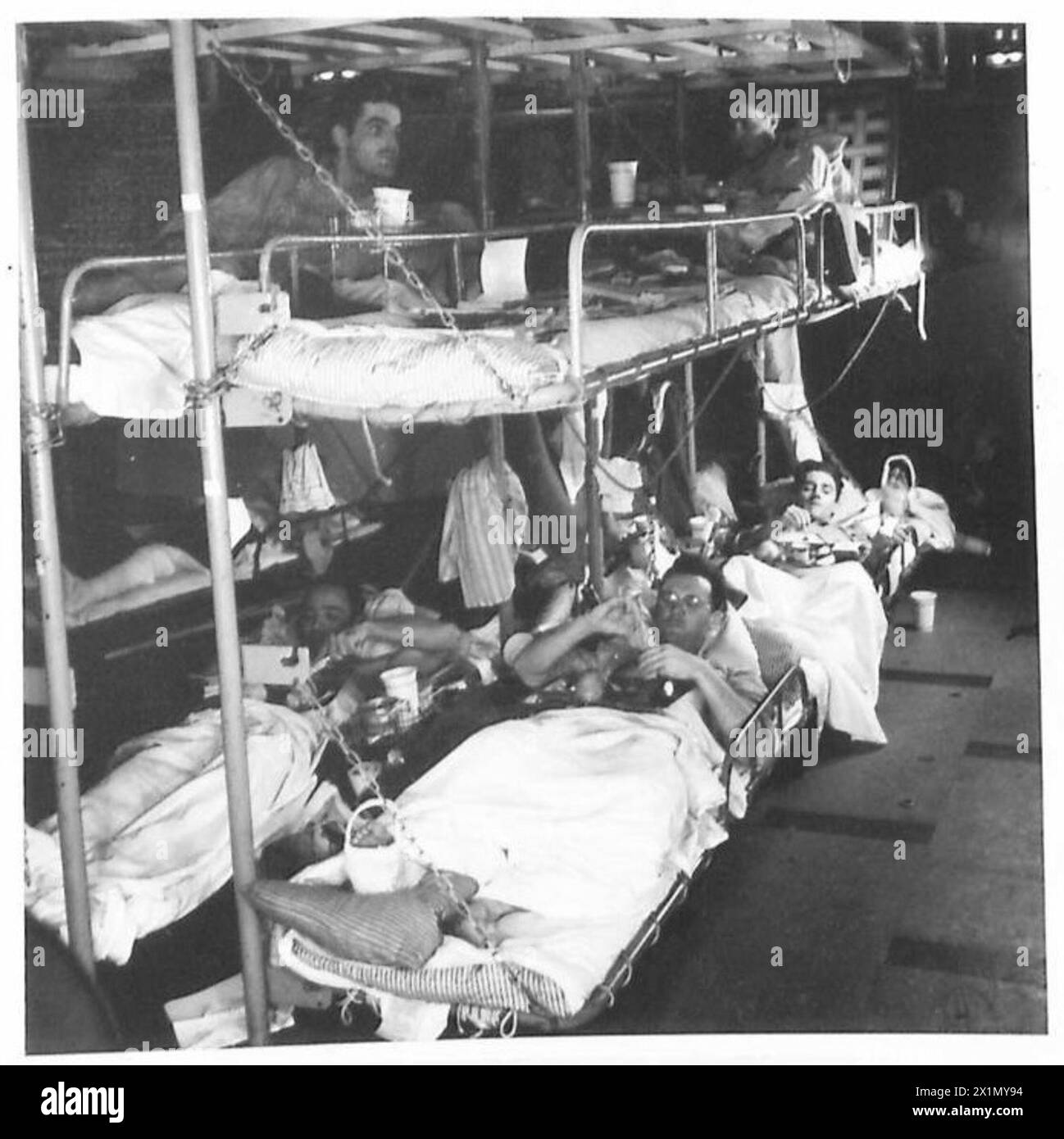Hospitalized patients aboard the troopship 'Queen Elizabeth' are being ...