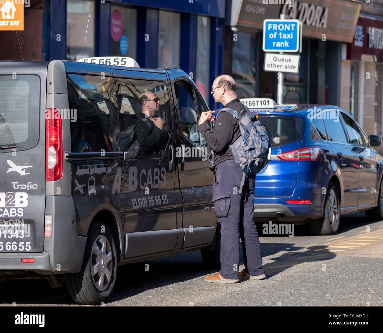 17 April 2024.Elgin,Moray,Scotland. This is a man chatting to a Taxi ...