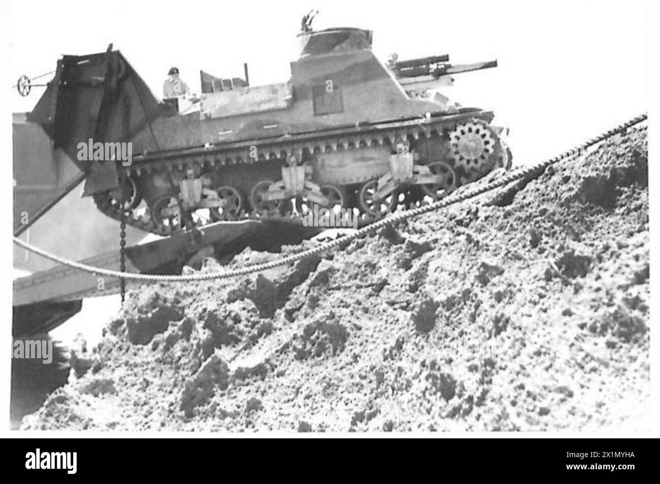 TANK LANDING EXERCISE - A "Priest" 105mm self-propelled gun leaving an ...