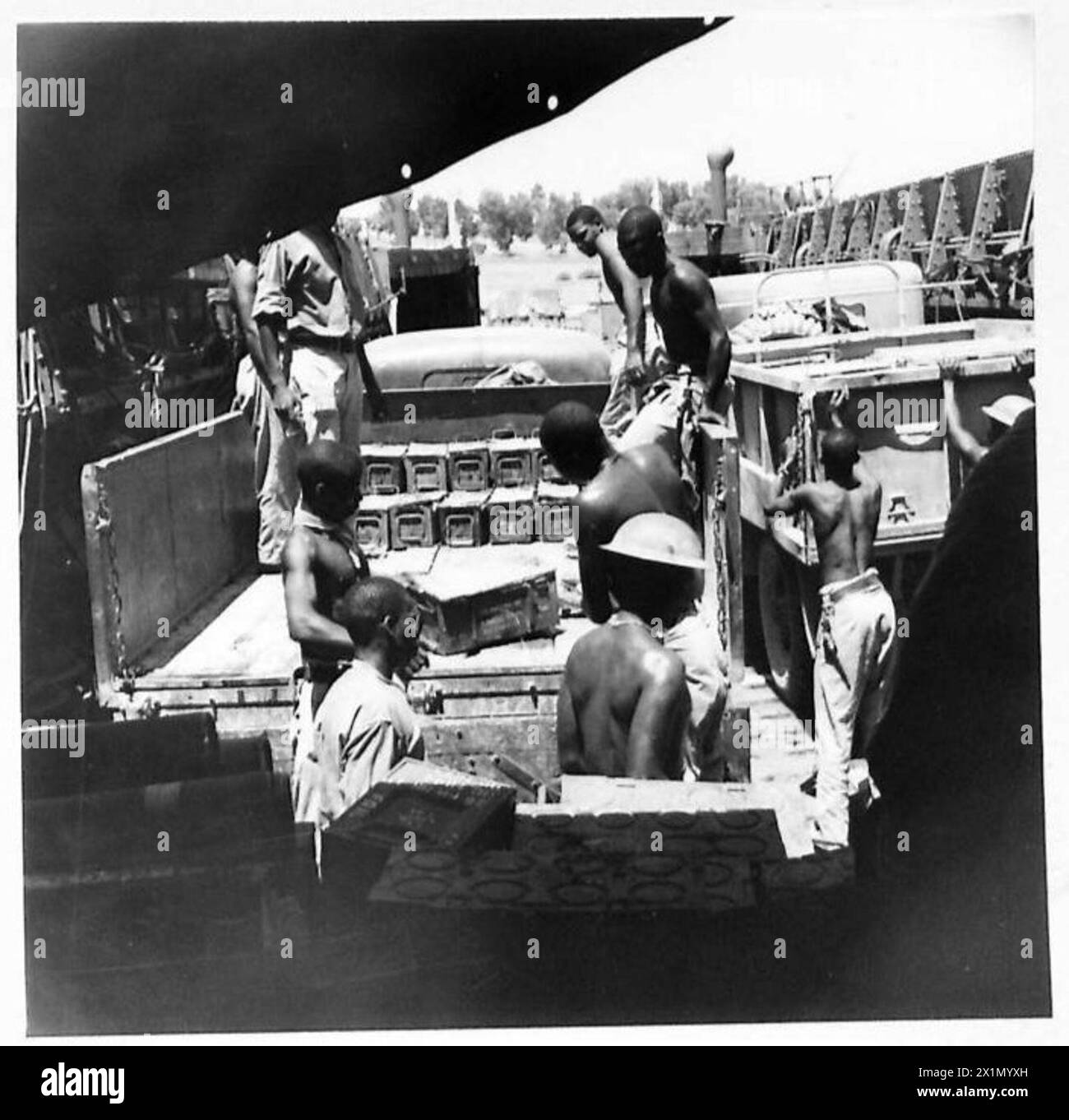 At the captured Augusta base, lorries are loaded onto LCTs with ...