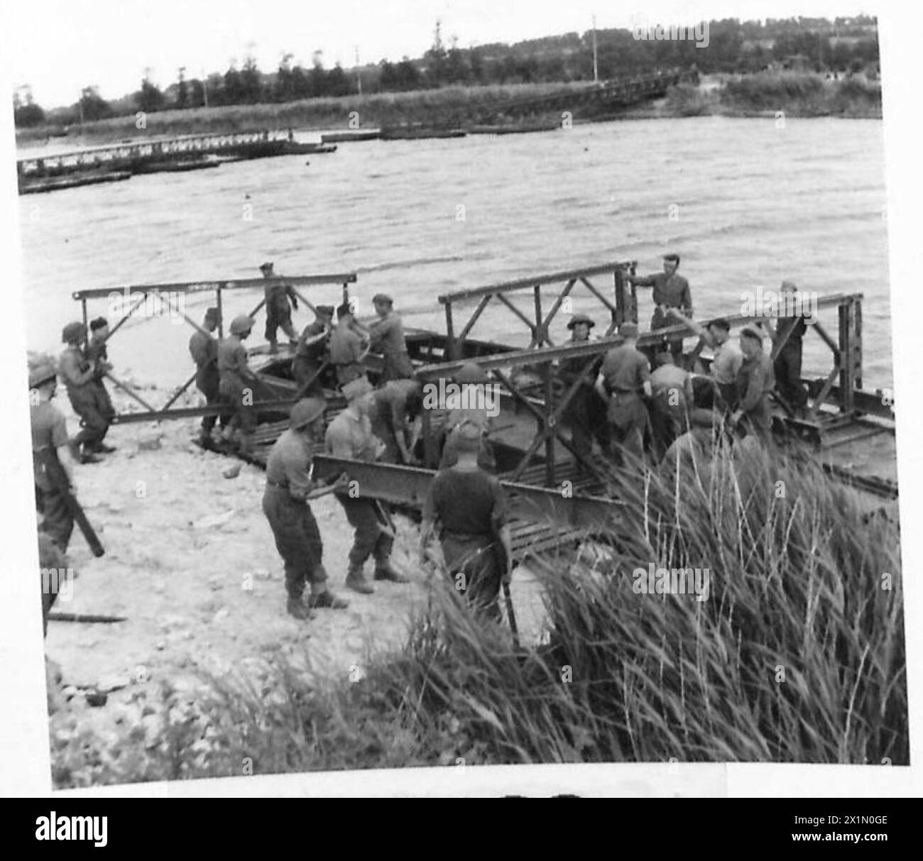 Royal Engineers position the final sections of a Bailey bridge ...