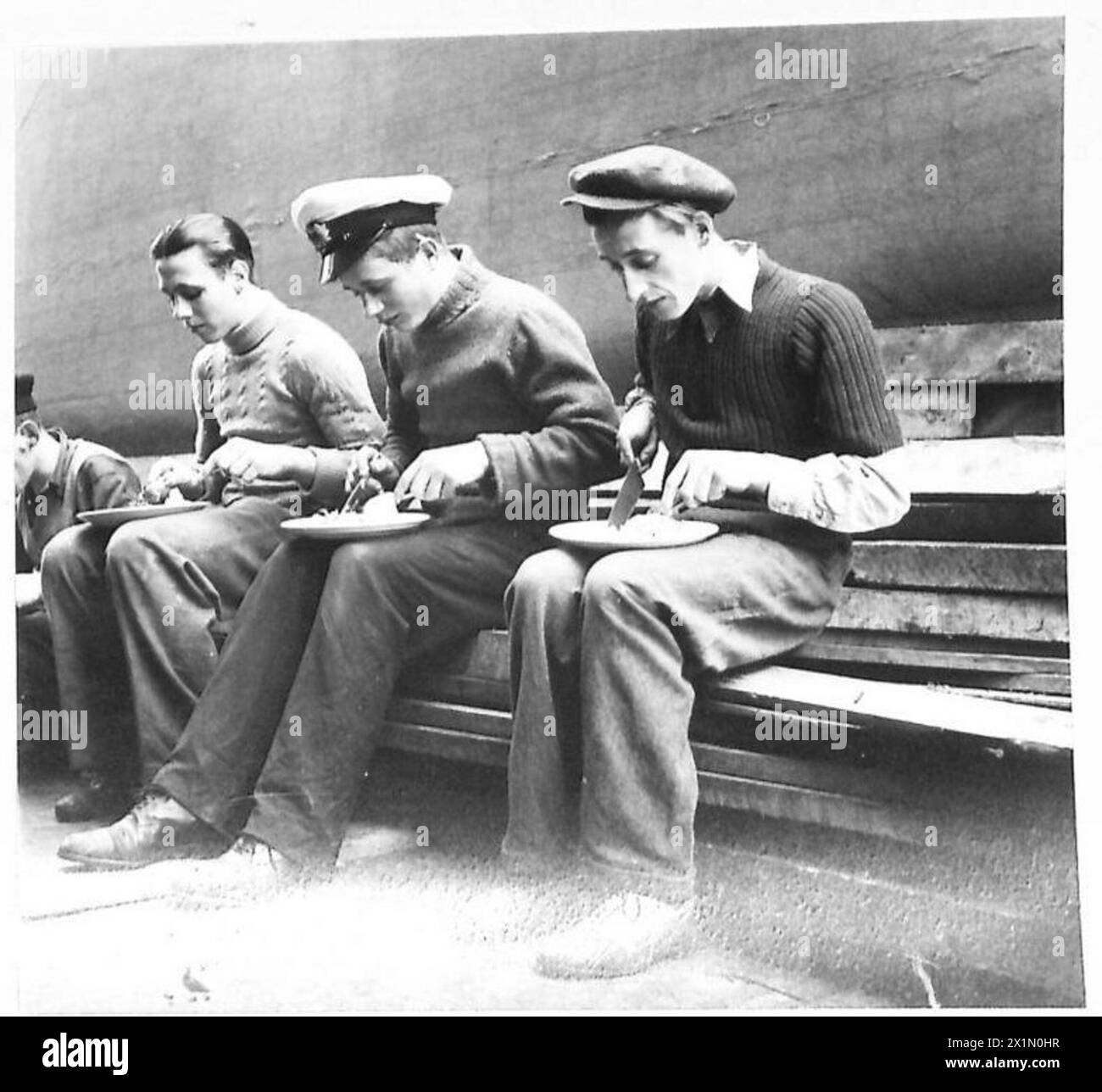 Catering staff on an African-bound convoy ship are shown having dinner ...