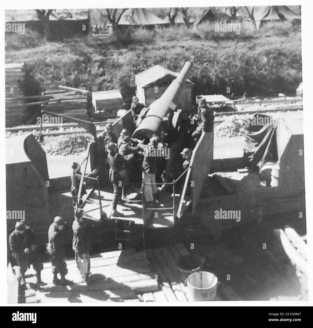 A shell is rammed into the breech of a railway gun by personnel of the ...