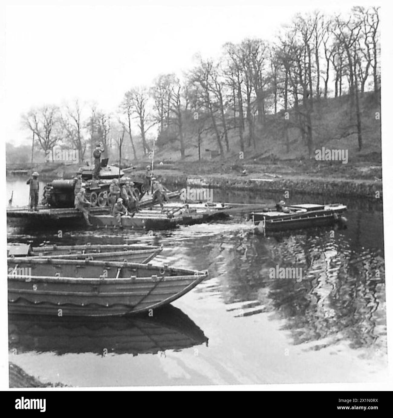 A Crusader tank is loaded onto a shore loading raft and ferried across ...