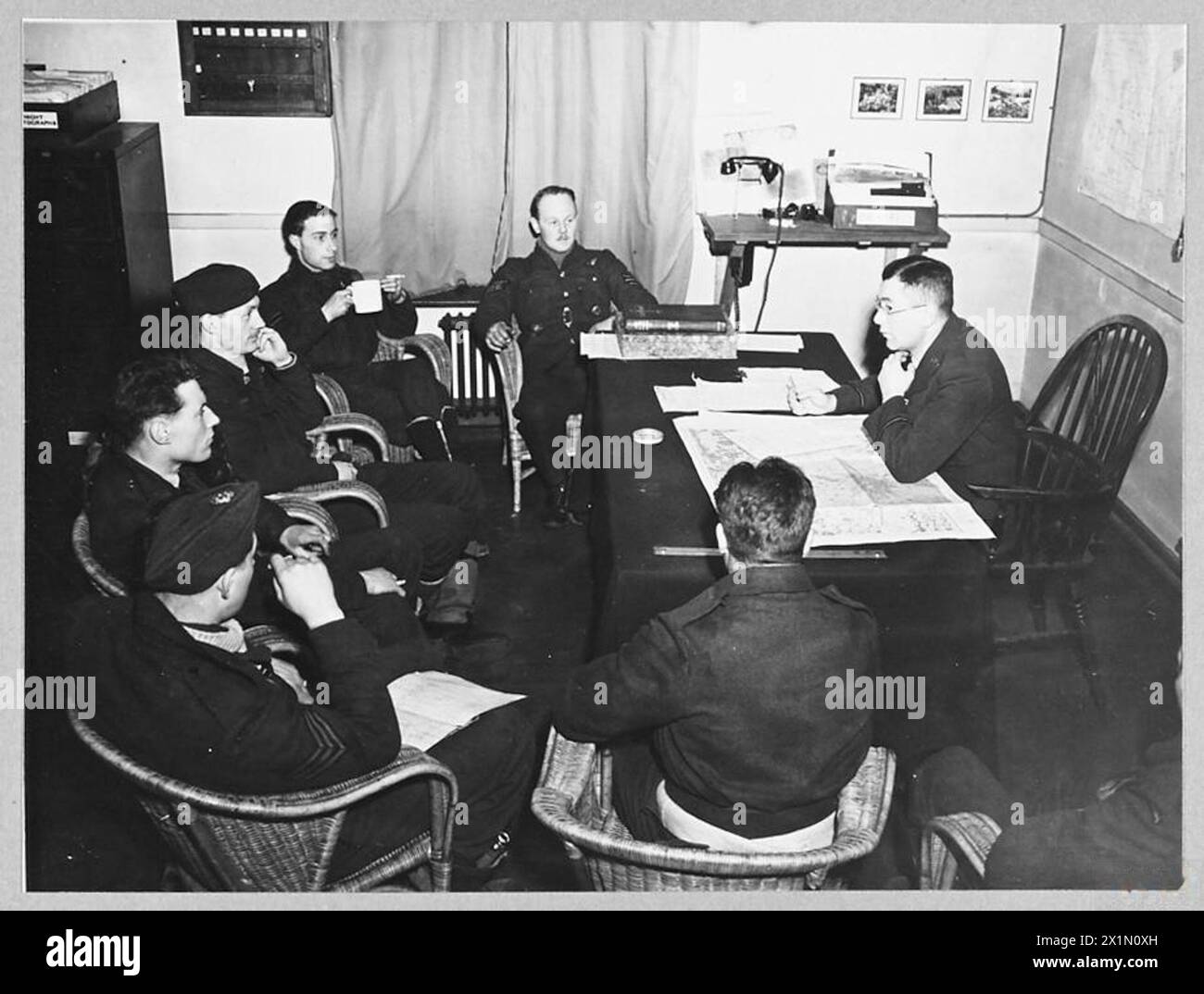 RAF Bomber Command crews at a station are interrogated by intelligence ...