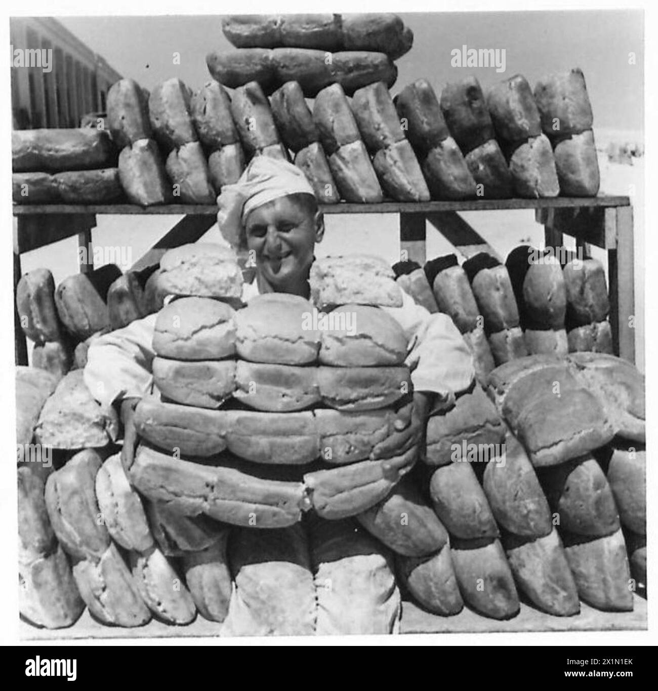 A BAKERY IN THE WESTERN DESERT - A stack of newly baked loaves all ...