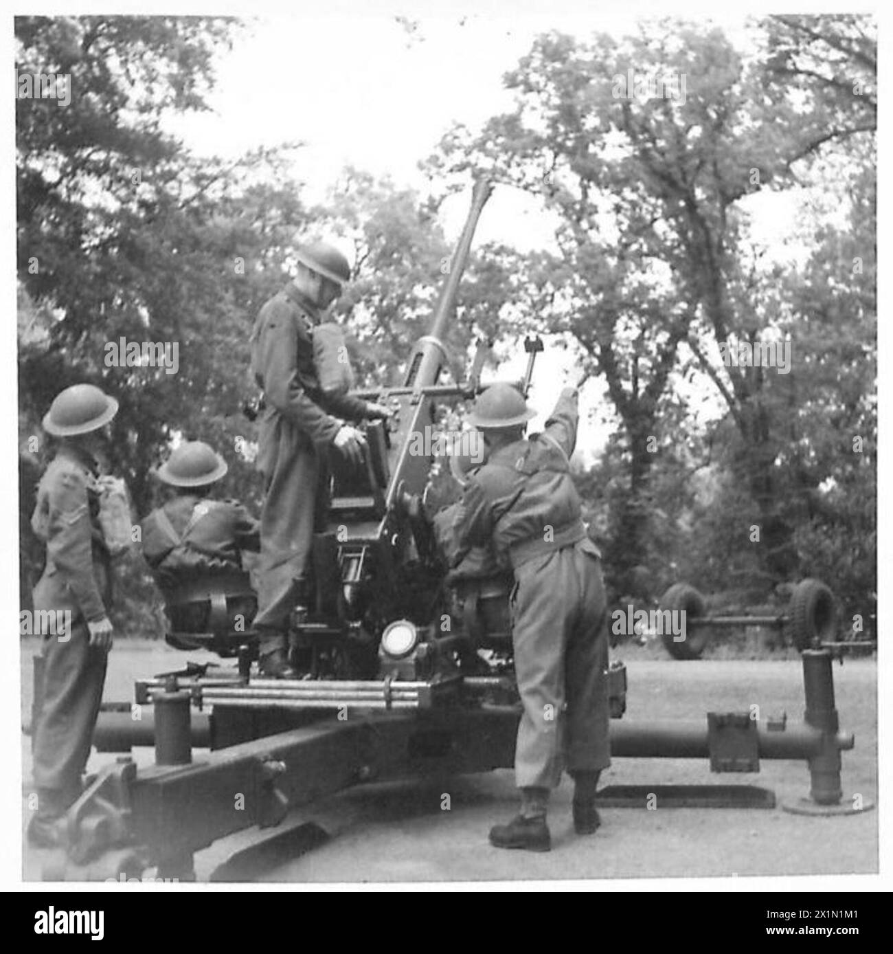 BOFORS GUNNERS IN TRAINING - The detachment commander indicates target ...
